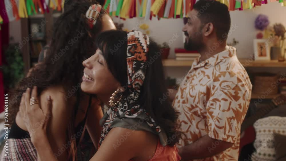 Medium zoom out footage of two Mexican men shaking hands, and women ...