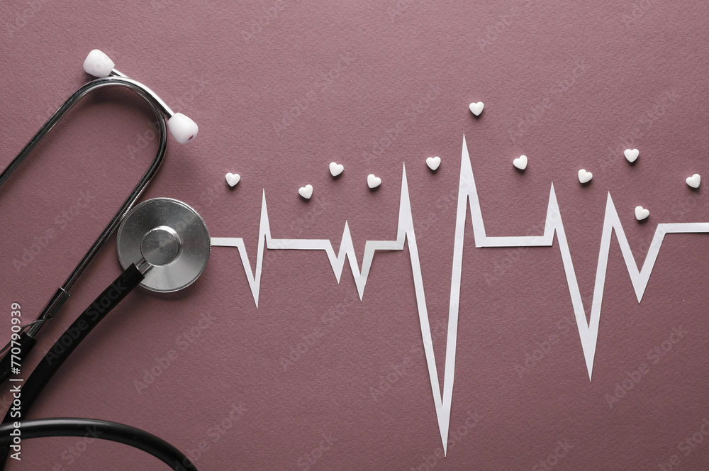 Diagnosis of heart diseases. Paper-cut heart rhythm cardiogram with ...