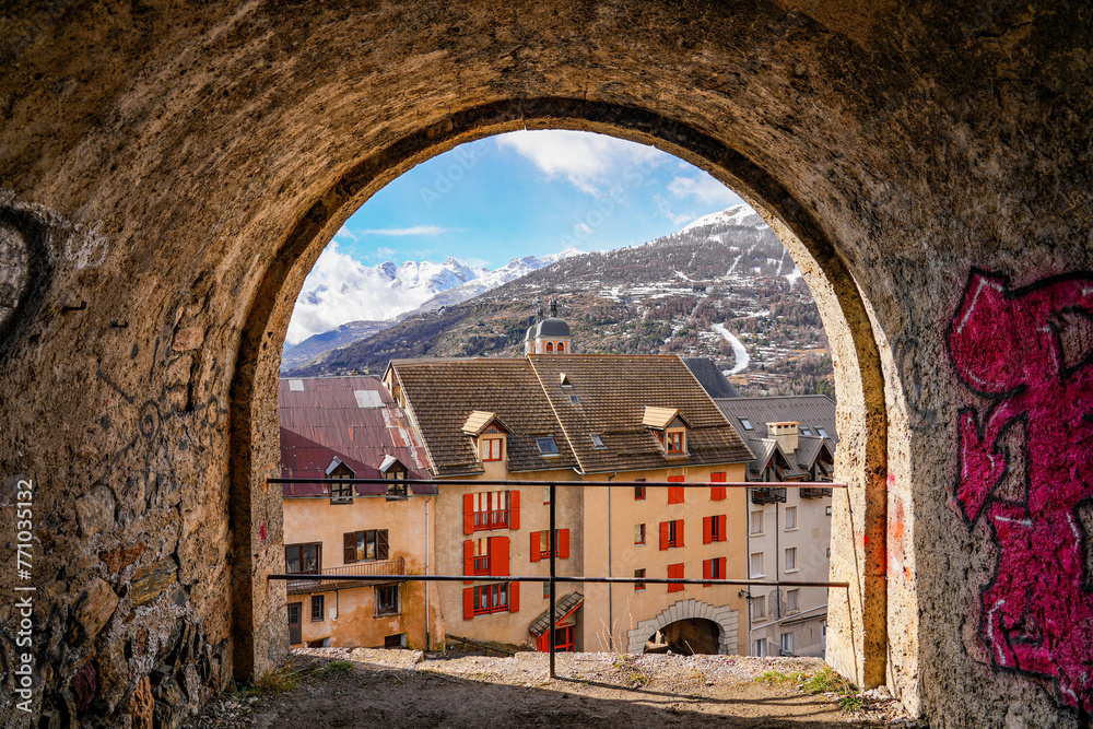 View of the old town of Briançon from a vaulted passage of the ...