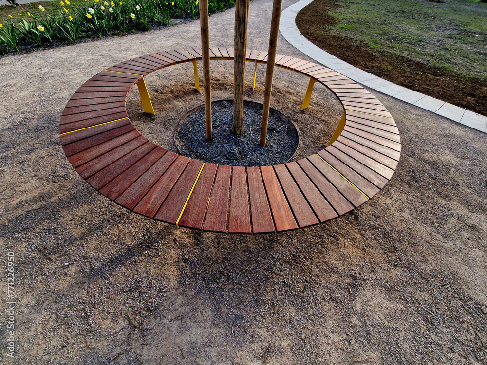 round bench made of wood encloses a tree, sitting around with wood ...