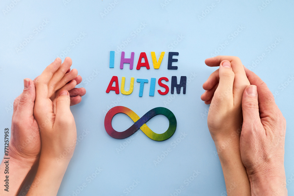 Autistic boy and father hands with rainbow eight infinity symbol ...