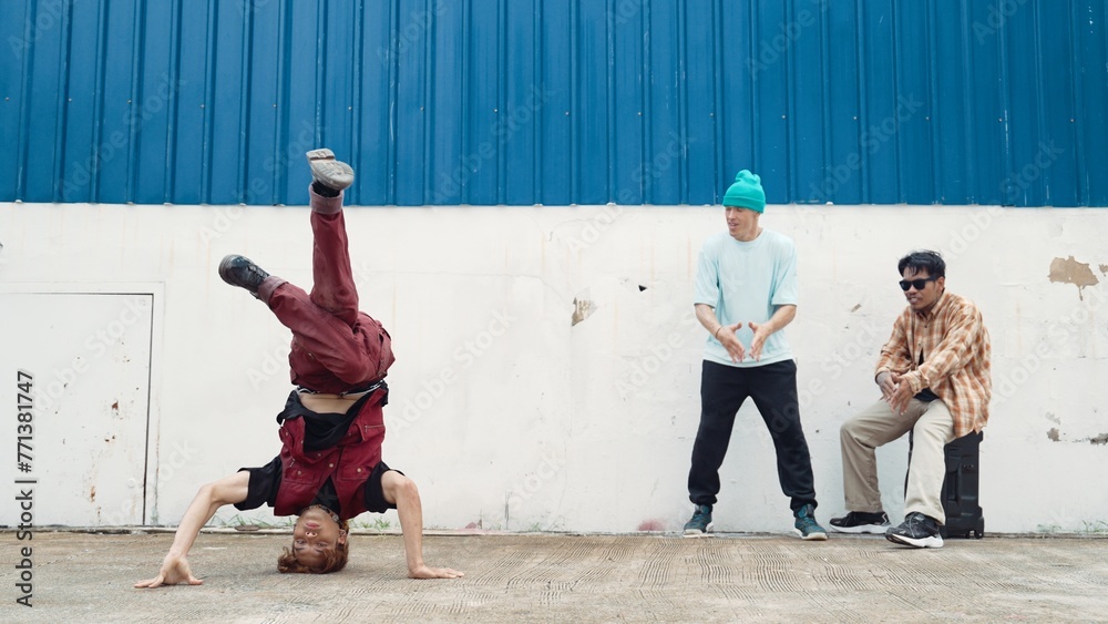 Young street dancer dancing in hip hop style with multicultural friends ...