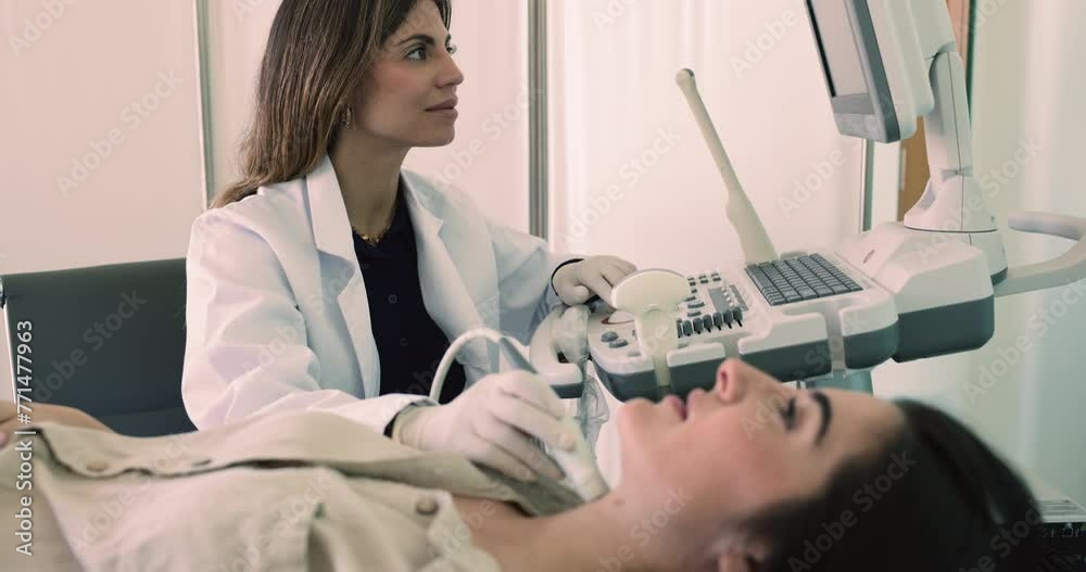 Close up of young female endocrinologist doctor check patient thyroid ...