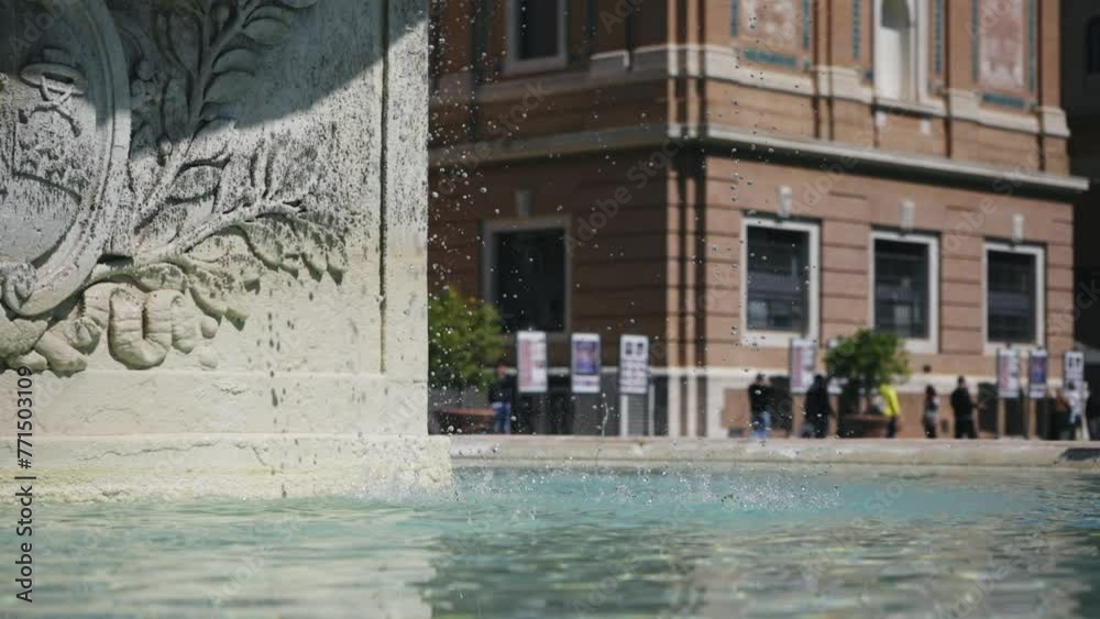 Establishing shot of fountain water splashing in slow motion at ...