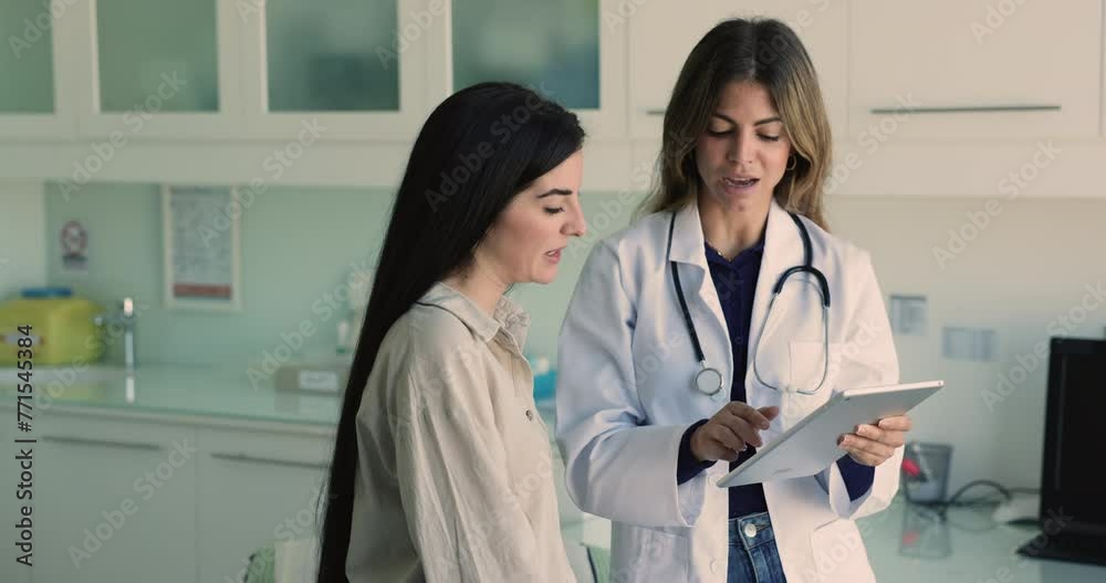 Latin GP showing to woman patient health test results using modern ...