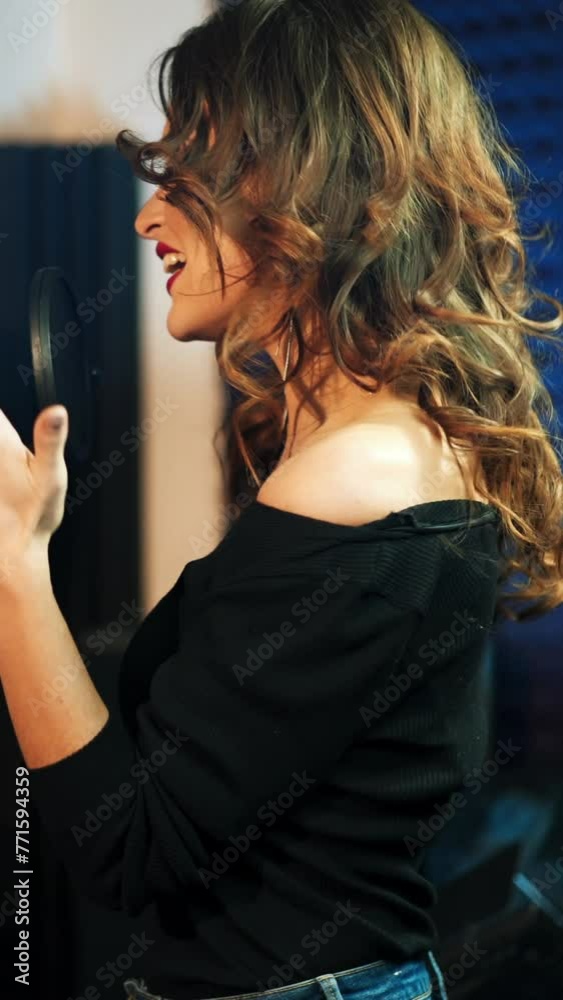 Half-length profile of a beautiful singer in the recording studio ...