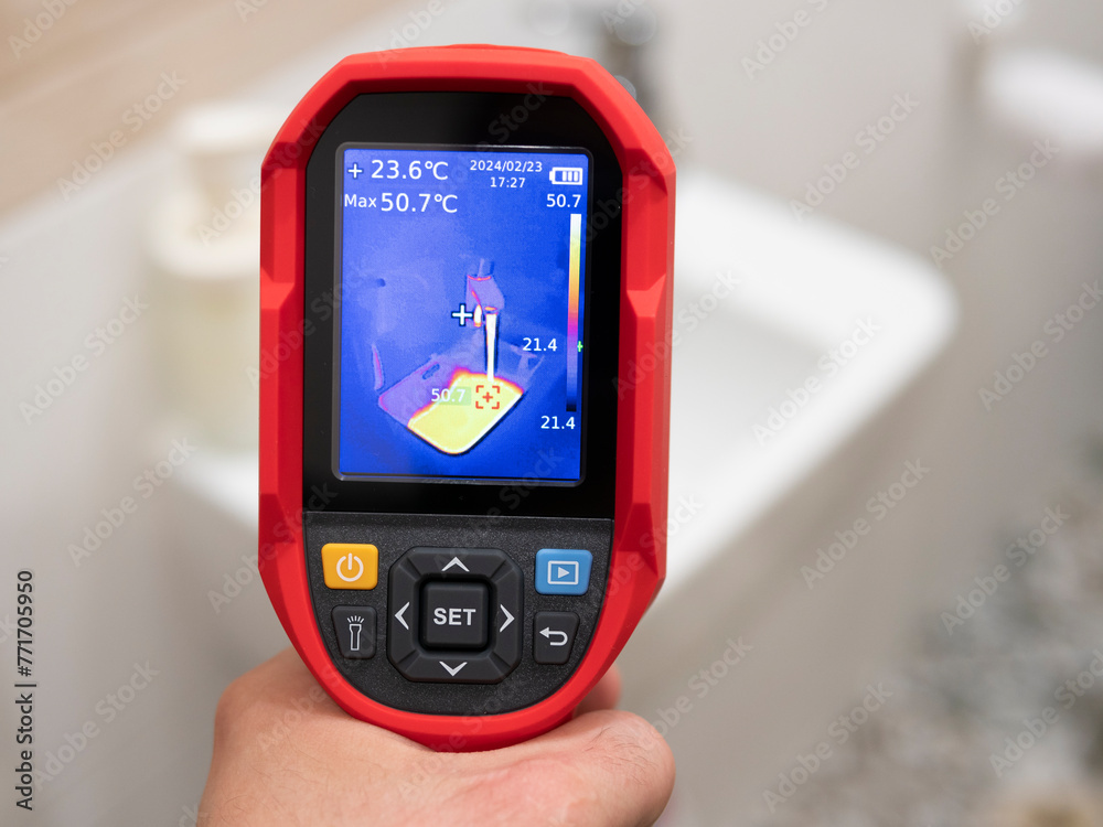 Thermal imaging inspection of heating equipment. A worker checks the ...