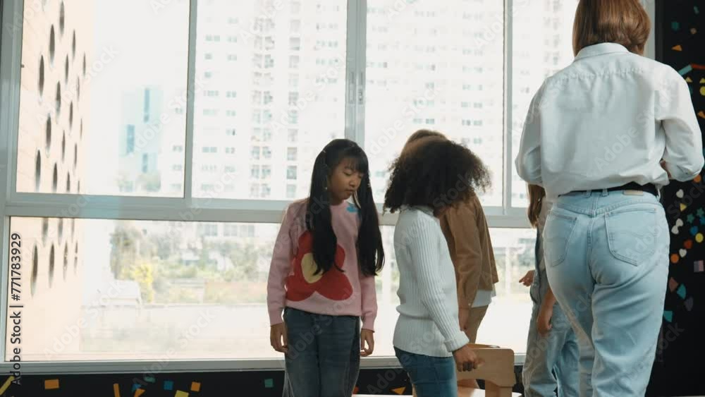 Diverse children playing musical chairs games while young smart ...