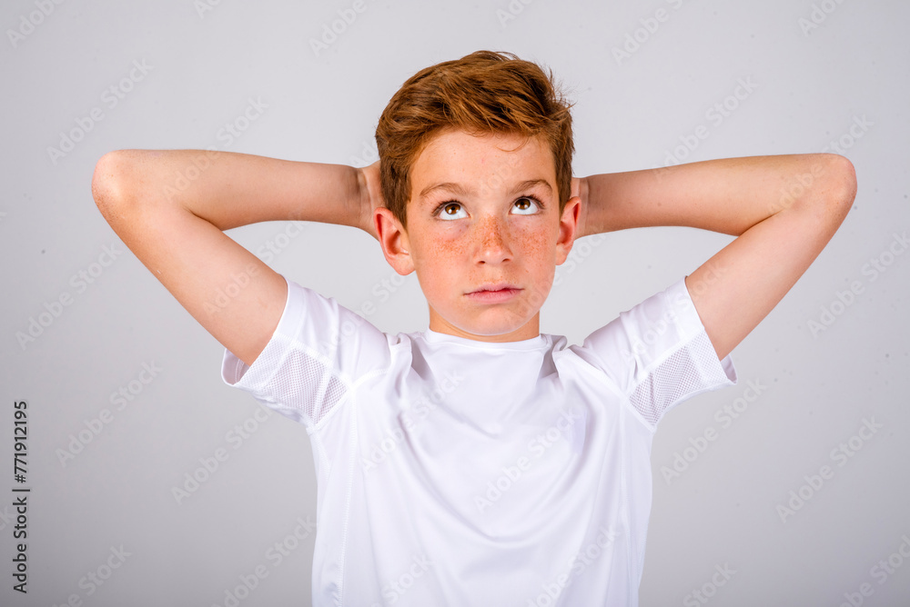Head and shoulders portrait of a preteen boy with freckles and auburn ...