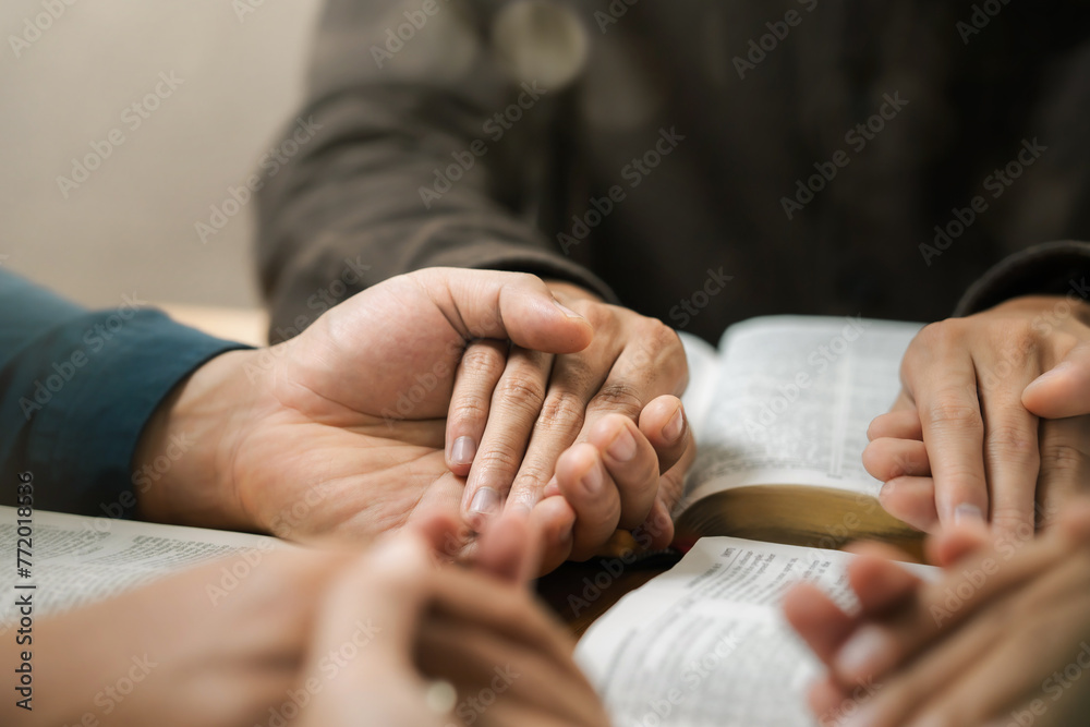 Group of young Christians praying, holding hands and praying together ...