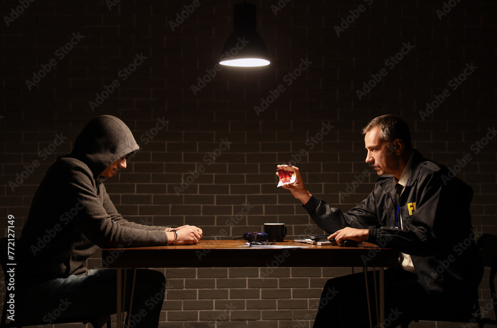 Mature FBI agent questioning suspect in interrogation room Stock Photo ...