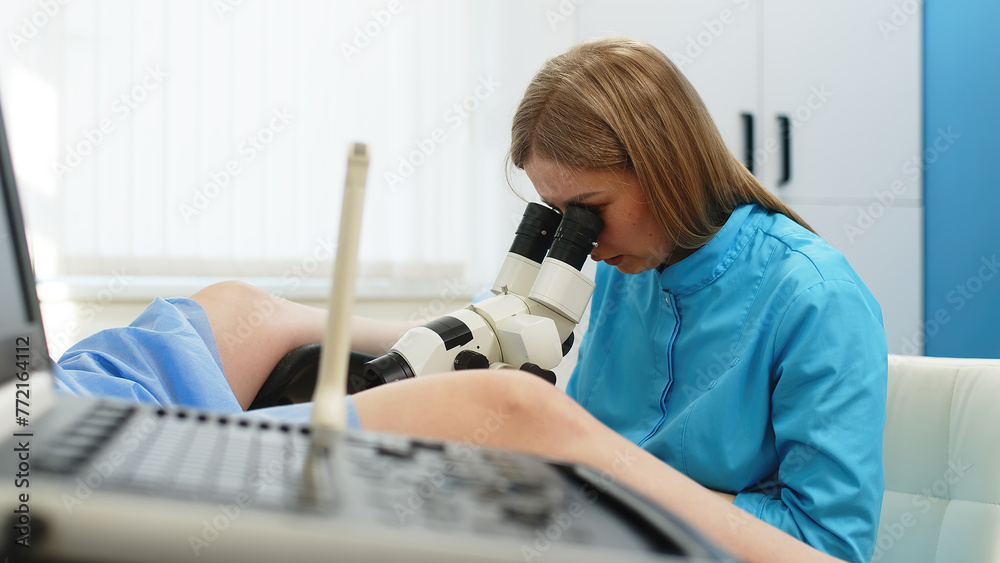 Gynecological office in a modern hospital. The gynecologist uses a ...