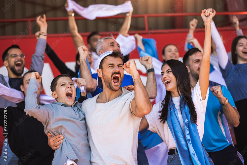 Football / soccer fans are cheering for their team at the stadium on ...