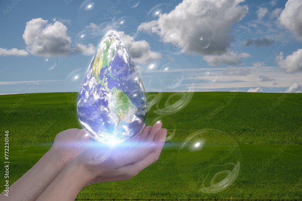 earth day concept saving our planet earth hand holding a water drop ...