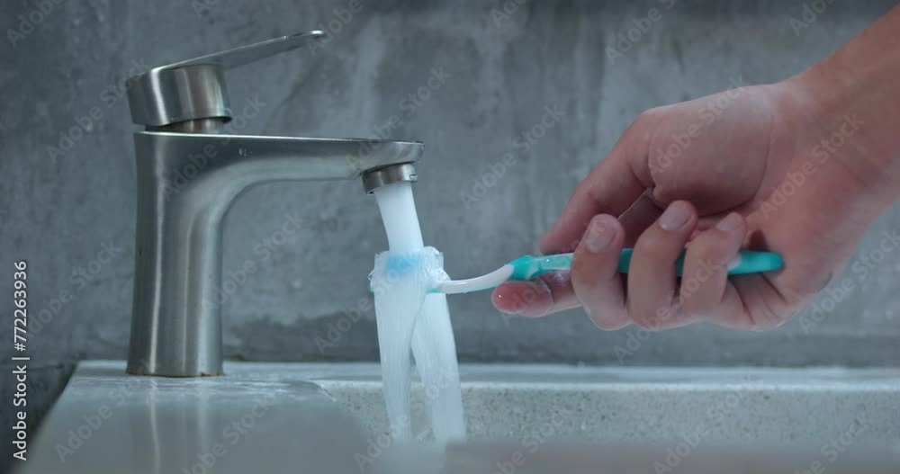 hand opens tap brings toothbrush washes. Highlighting cleanliness video ...