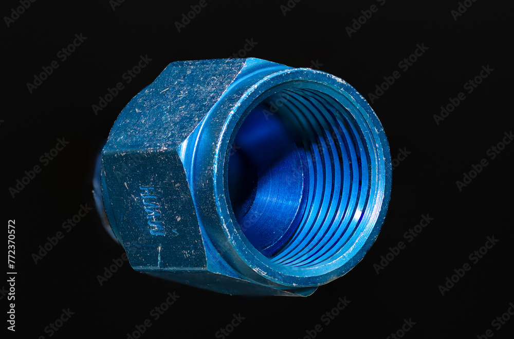 Inside threads of blue AN type hose fitting cap. Used in industrial ...