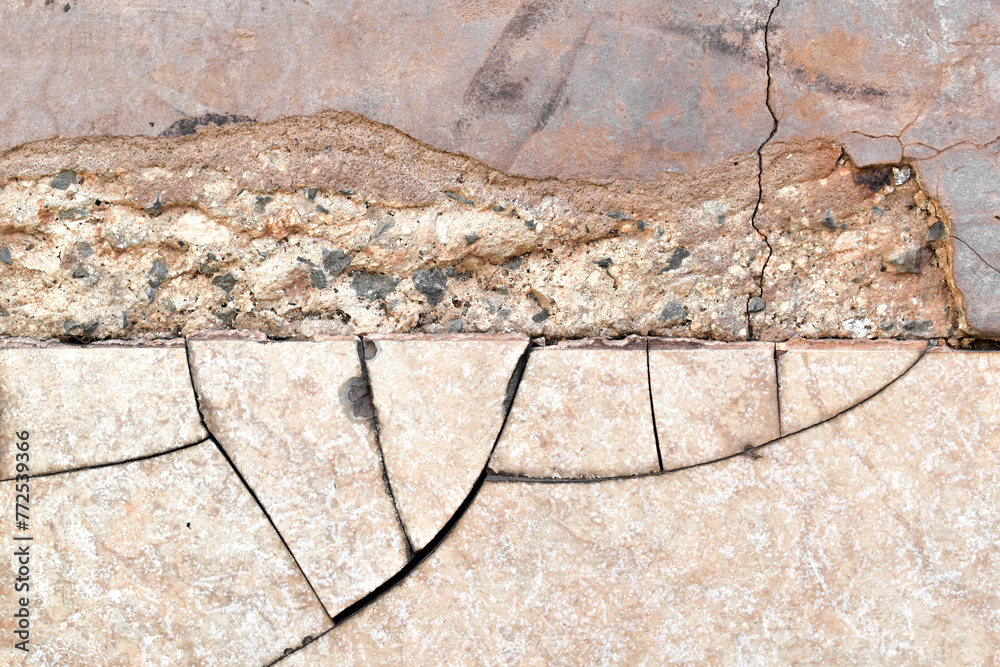 Cracked tiles and broken stamped concrete floor texture background ...
