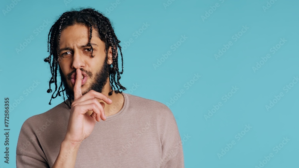 Fotka „Annoyed Middle Eastern man doing shushing hand gesturing ...