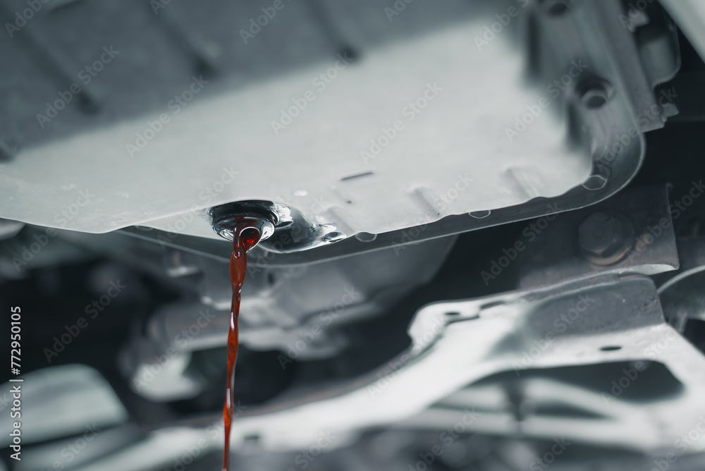 Close-up view of motor oil being drained from a car during a routine ...