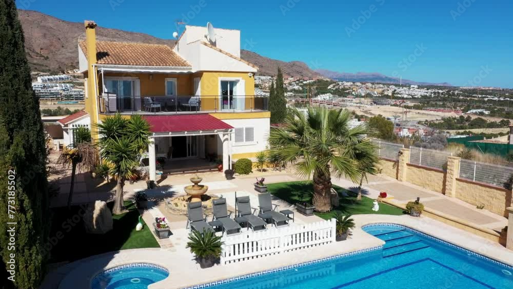 Aerial drone footage of a beautiful house in the town of Benidorm in ...