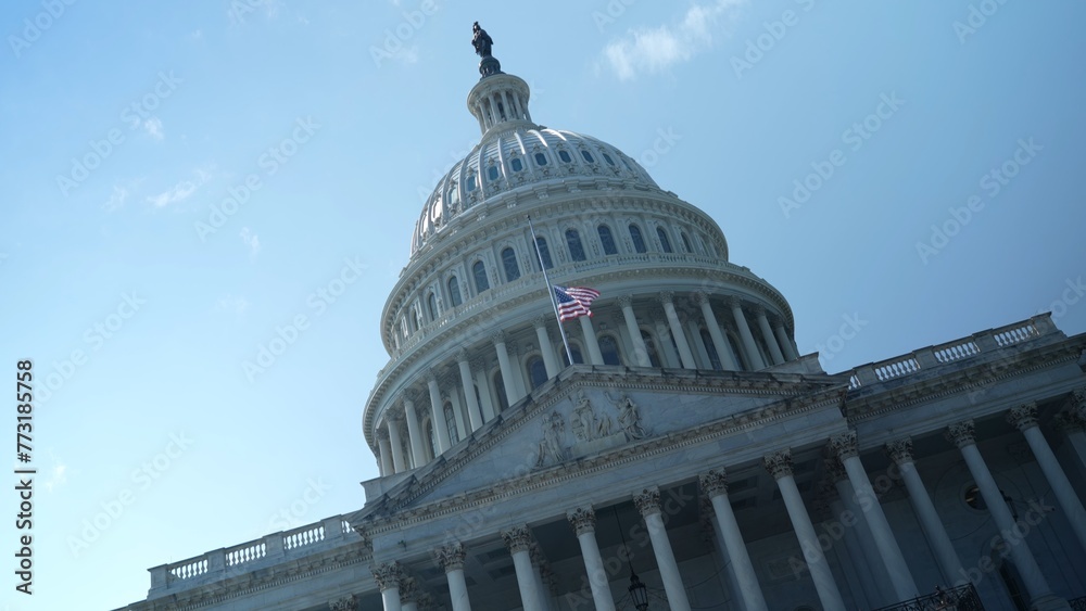 Angle view of the US Capitol dome with flag at half mast feeling chaos ...