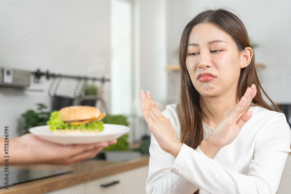 Diet, struggle asian young woman hand gesture reject to eat burger ...