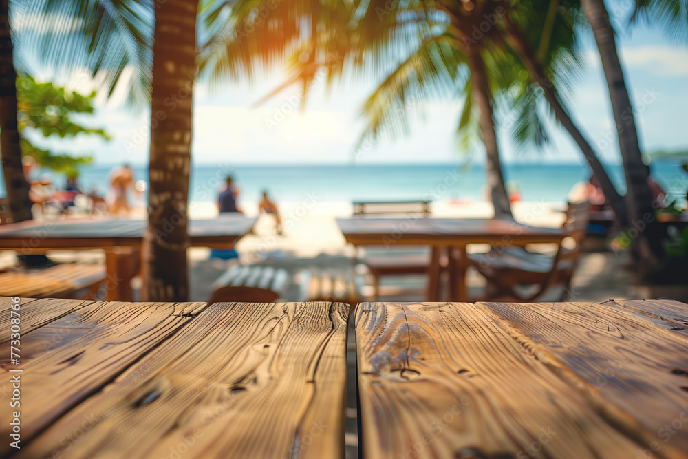 Wooden table top with blurred background of beach and palm trees in a ...