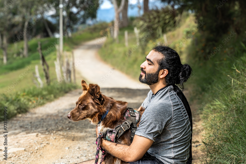 adult male mestizo meditating with his eyes closed while hugging his ...