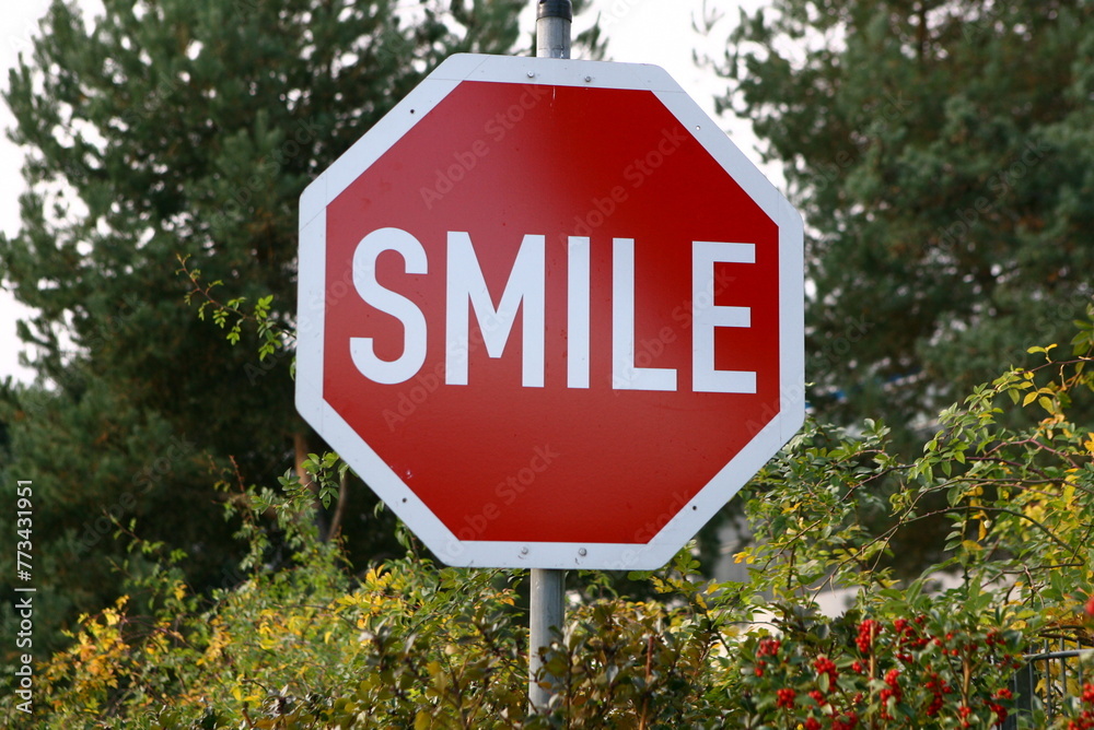 Stop sign with text "Smile" instead of stop. Someone has altered the ...