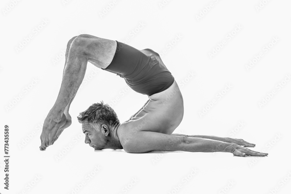 Ganda bherundasana, Ashtanga yoga Side view of man wearing sportswear ...