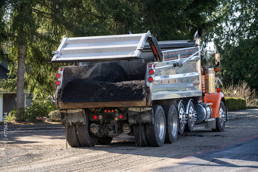 Dump truck with tailgate raised and filled with fresh hot asphalt ready ...