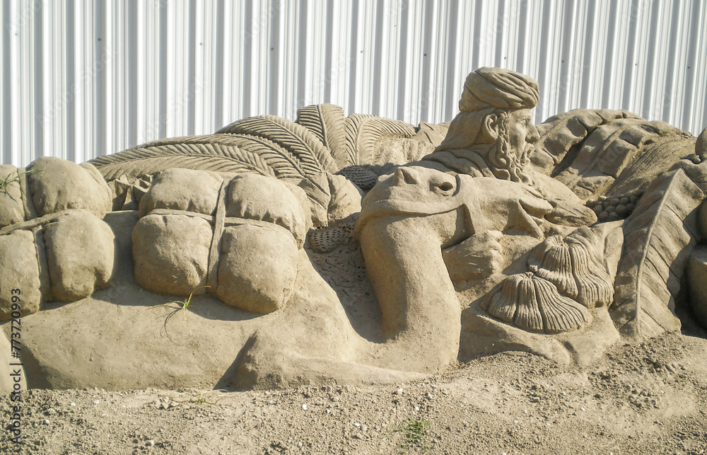Sandy caravanner with camel at sand figure festival based on Arabian ...