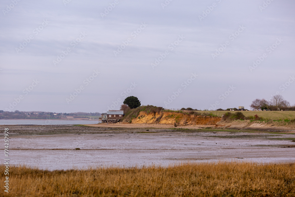 View of Wrabness beach from across the bay, Image shows the small beach ...