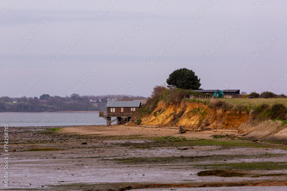 View of Wrabness beach from across the bay, Image shows the small beach ...
