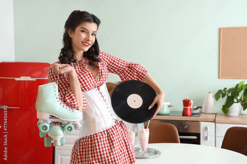 Beautiful pin-up waitress with roller skates and vinyl disc in cafe ...