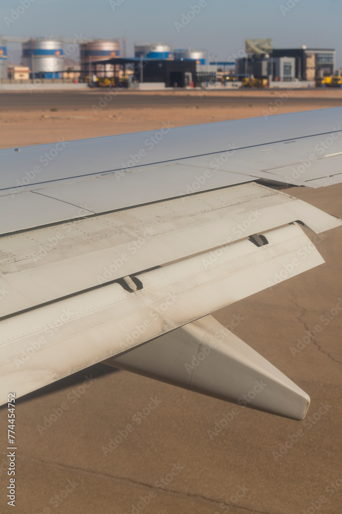 The plane lands on the airfield. Spoilers and flaps trailing edge when ...