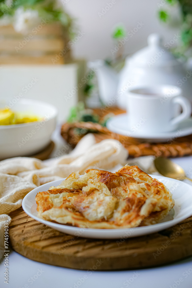 Roti Parata or Roti canai with curry sauce, a popular Malaysian ...