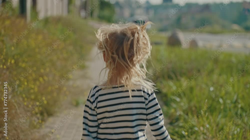 Cinematic tracking shot, rear view, camera follows an unrecognizable ...