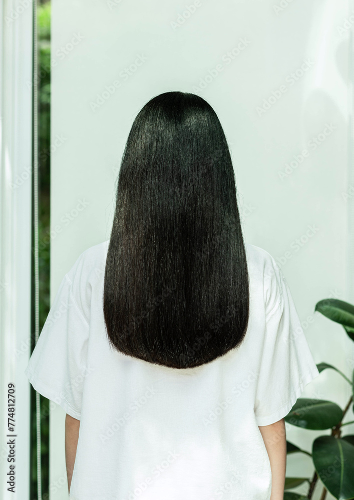 Back of beautiful young Asian teenage girl with long straight black ...