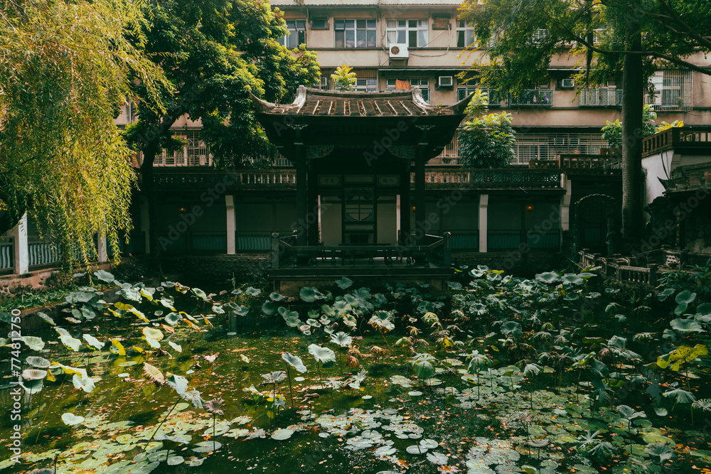 Ancient historic wooden mansion with pond and water lilies in the ...