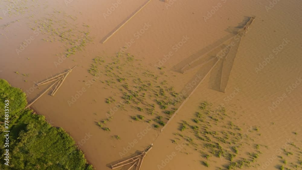 Arrow head fish nets in muddy waters on the Tonle Sap shore line, Asias ...