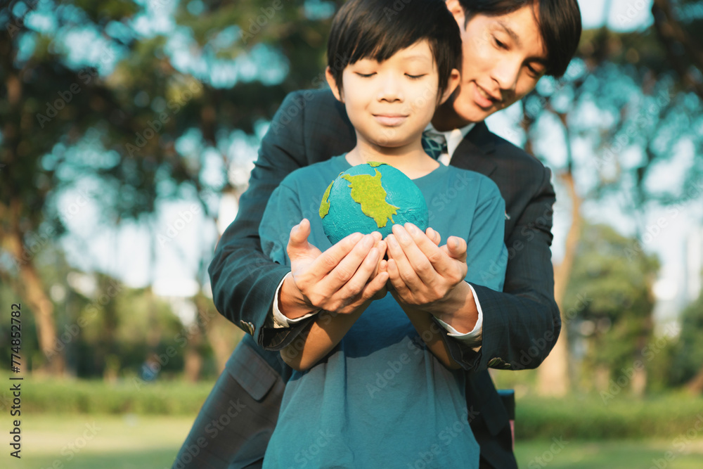 Asian boy and businessman holding planet Earth together as Earth day ...