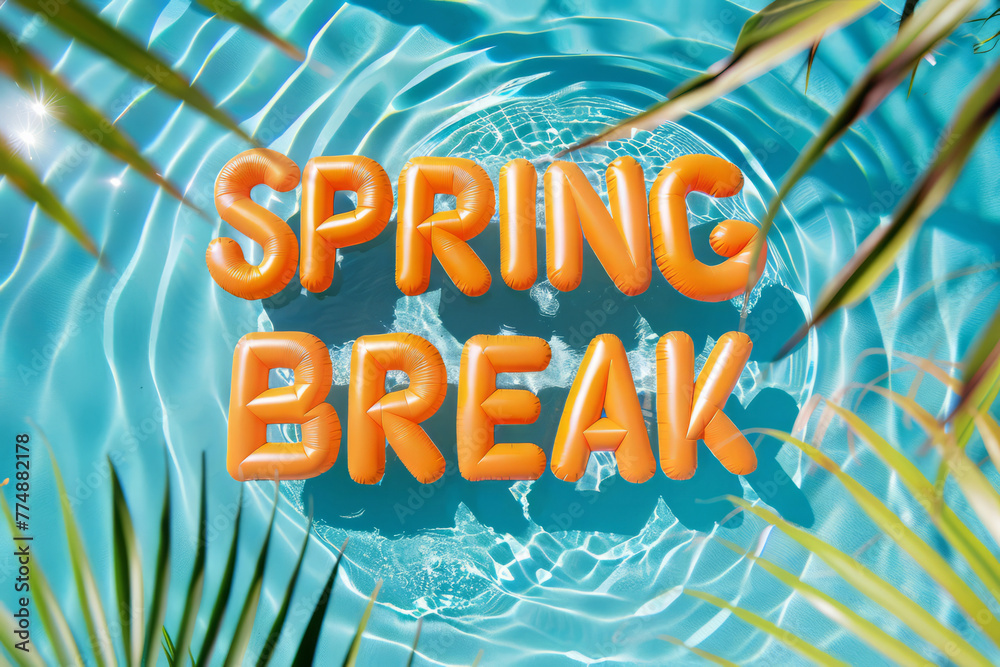 Spring break word spelled out in inflatable pool floats in a summer ...