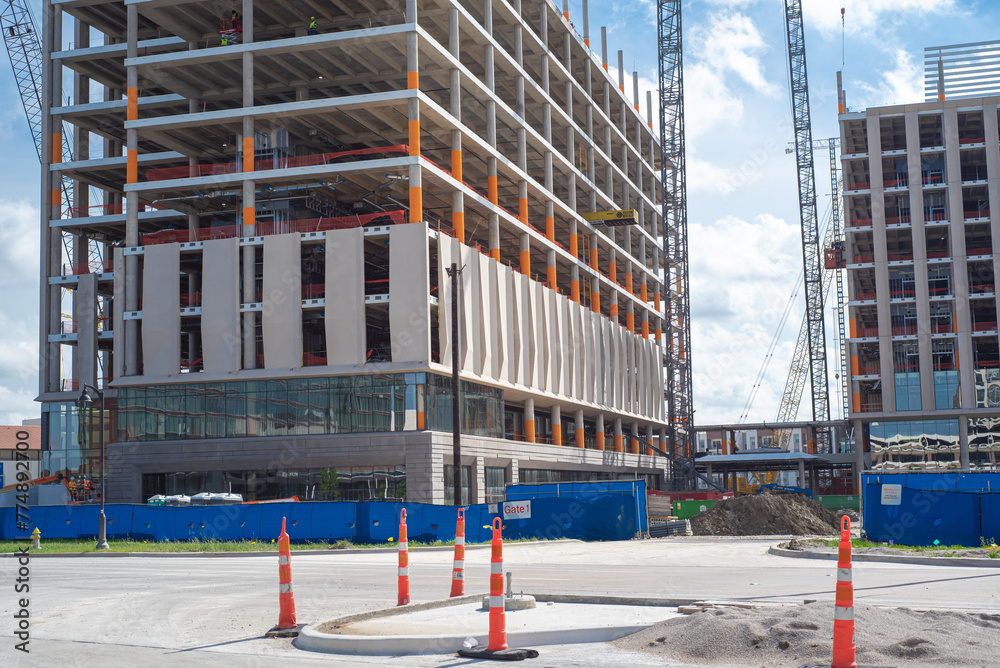 Construction site with cone yard sign, high-rise hotels, office ...