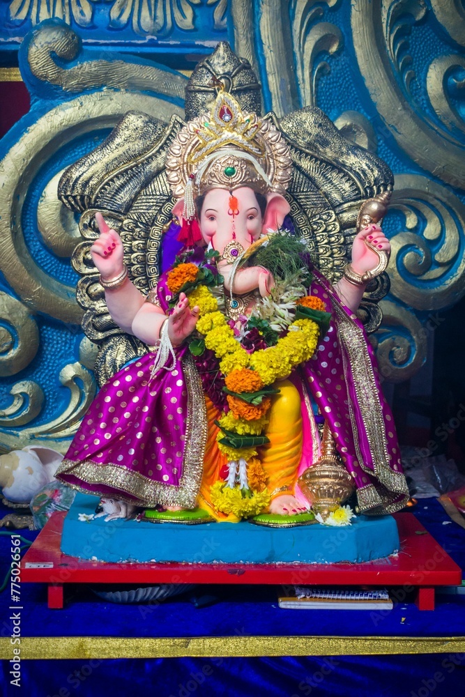 Vertical of the statue of Ganesh on a mandala for the auspicious Indian ...