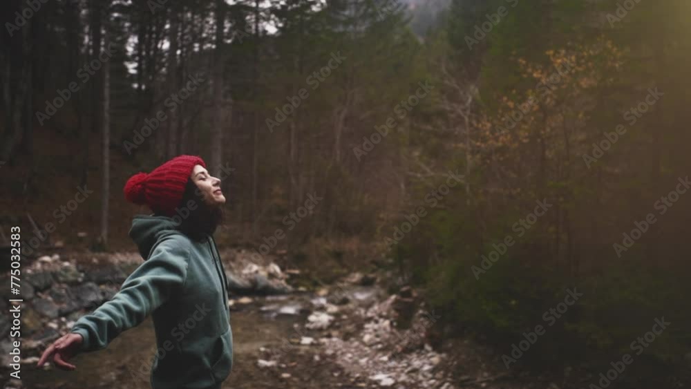 Lonely young mixed race woman raise up hands in virgin autumn forest ...