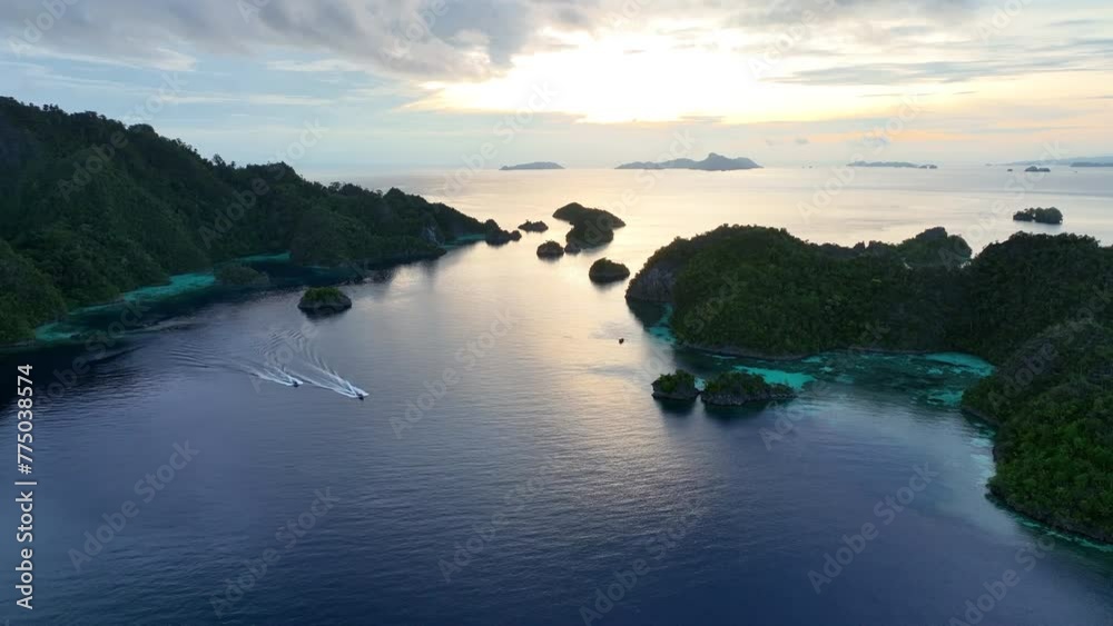 Scenic islands, surrounded by coral reef, rise from Raja Ampat's ...