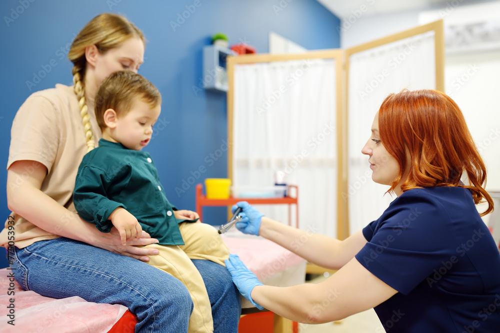 Cute toddler boy with his mother are at an appointment with pediatric ...