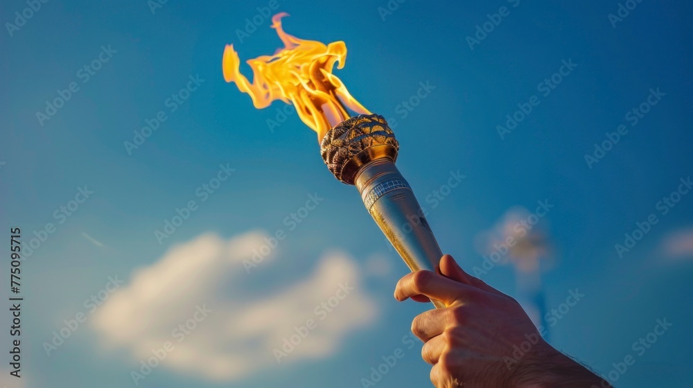 person holding the olympic torch with beautiful blue sky background in ...