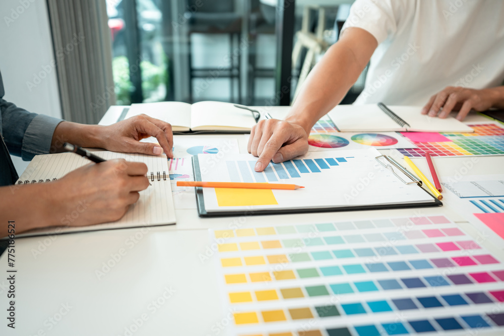 Two creative graphic designer team working on color selection and ...